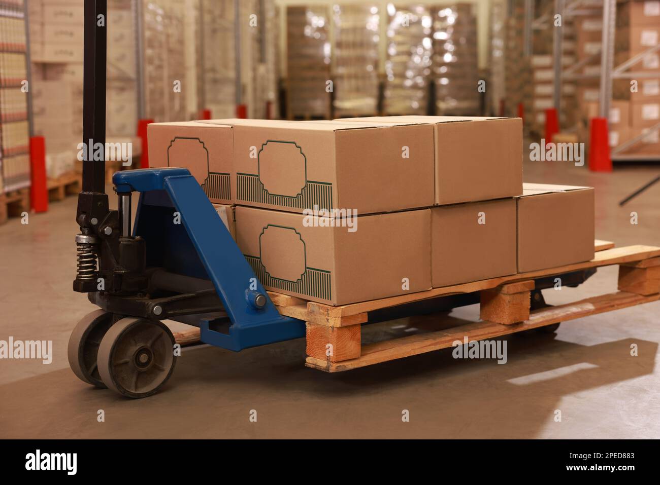Chariot élévateur manuel avec boîtes en carton dans l'entrepôt. Concept ...