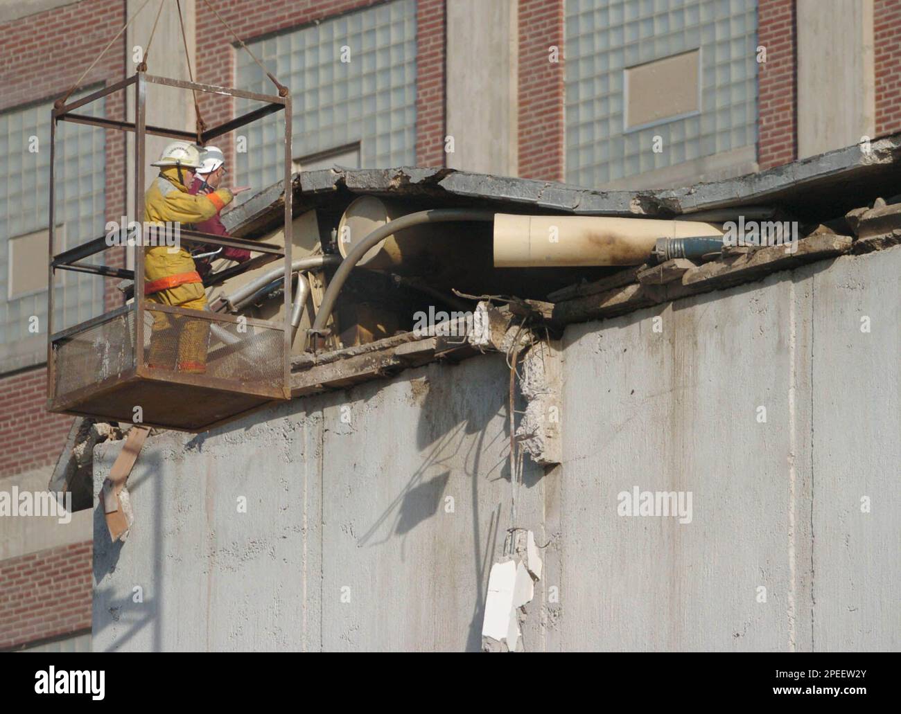Enid fire investigator Lt. Warren Rhodes looks underneath a section of ...