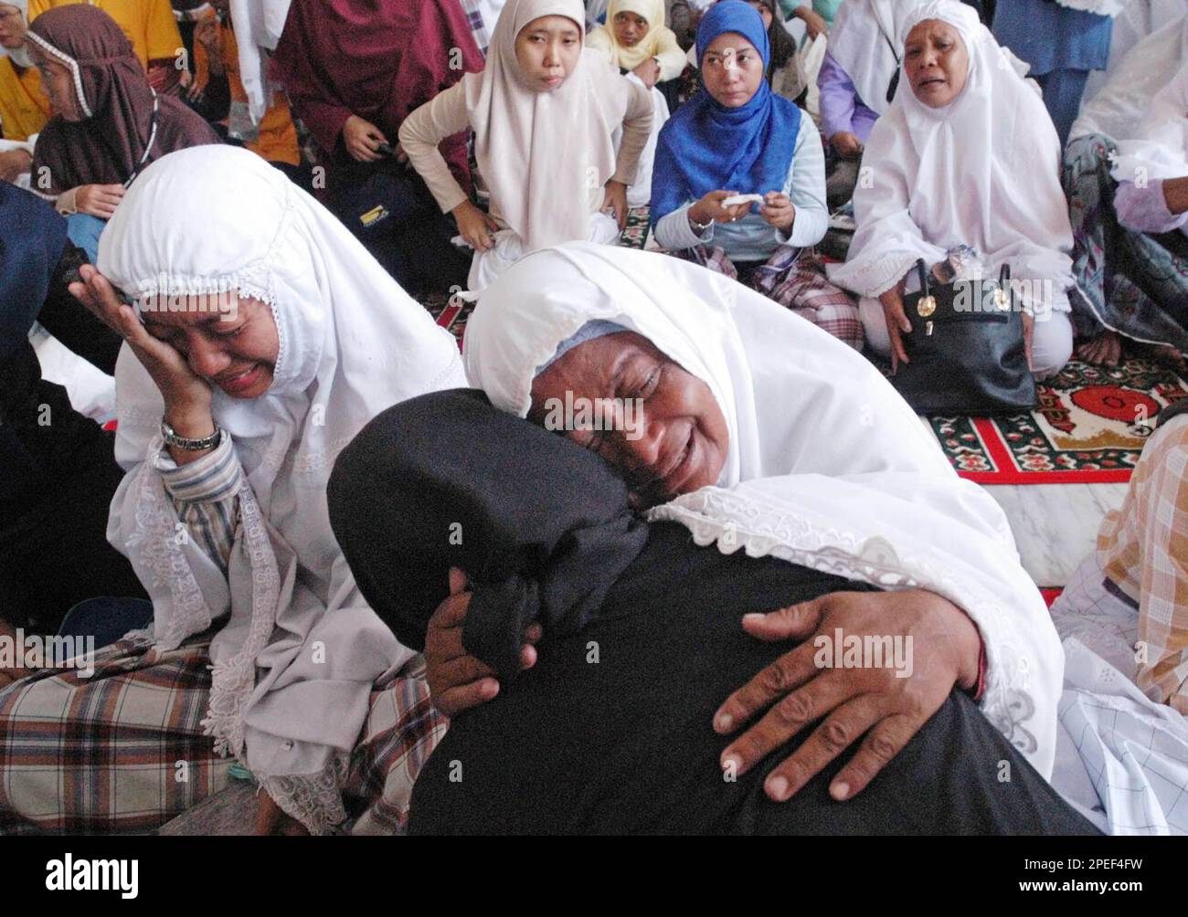 Muslim women cry at an Eid al-Adha prayer service at Raya Baiturrahman ...