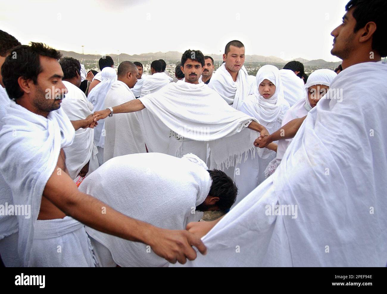 Pilgrims hold hands to make space for others to pray at Jabal Al Rahma ...