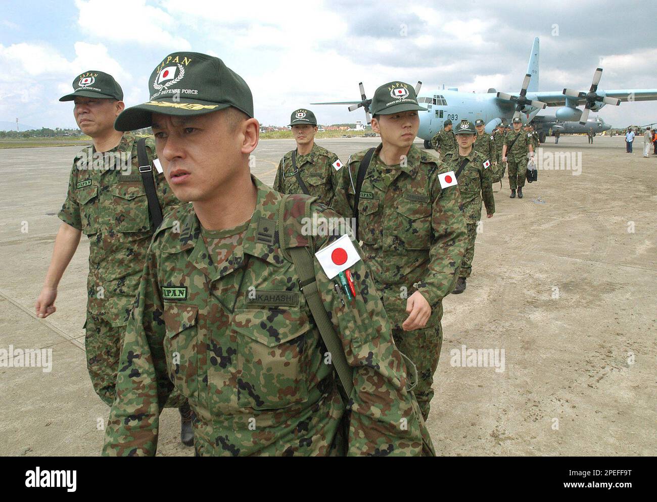 Japanese military medical team march upon their arrival in Banda Aceh ...