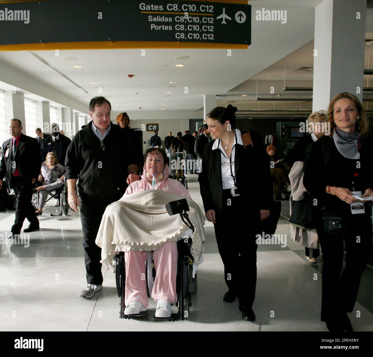 Brooke Ellison, center left, is accompanied by her father Ed Ellison ...