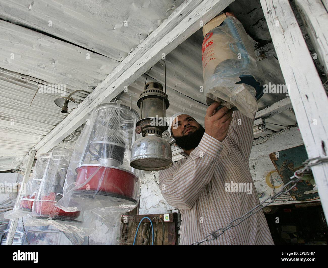 A Palestinian plumber Sayed Abul-Kheir, 35, hangs kerosene lamp on his ...