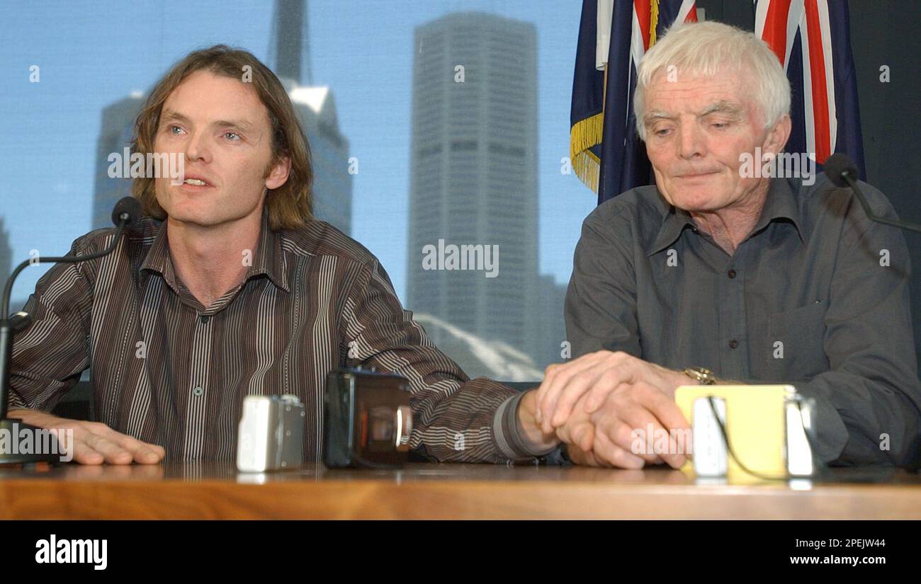 Hugh O'Gara, right, listens and holds the hand of his son Kevin O'Gara ...
