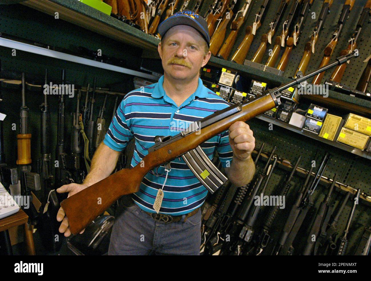 Gunsmith Justin Davis of the Boise Gun Co. holds a Ruger mini-14 rifle ...