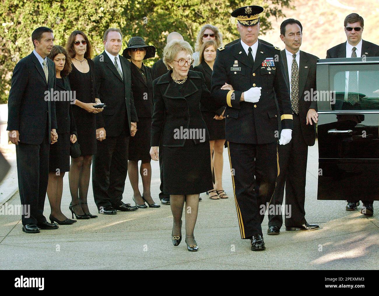 Nancy Reagan is escorted into the Ronald Reagan Presidential Library ...