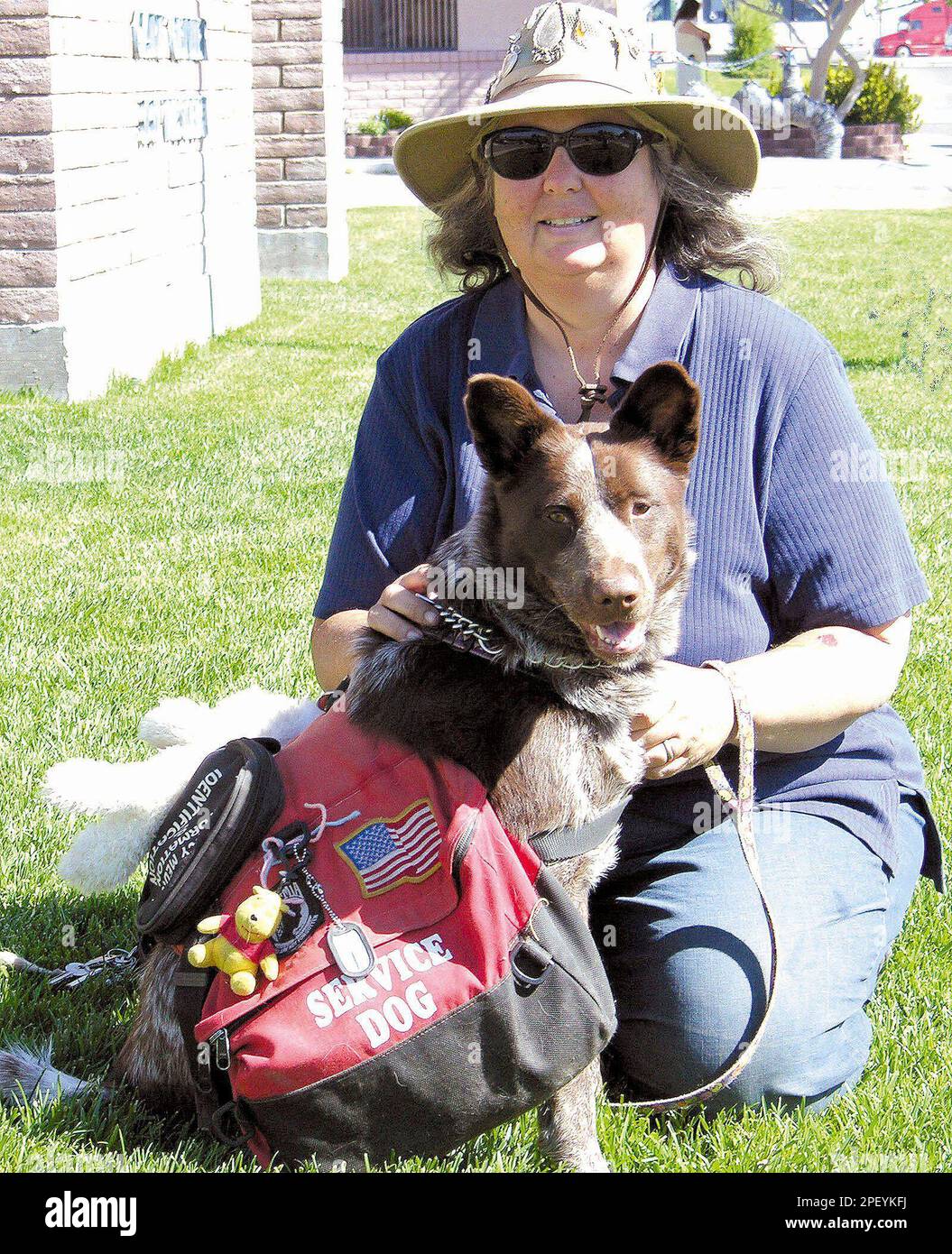Cherri Darnell poses with her service dog "Moppett" in Kingman, Ariz ...