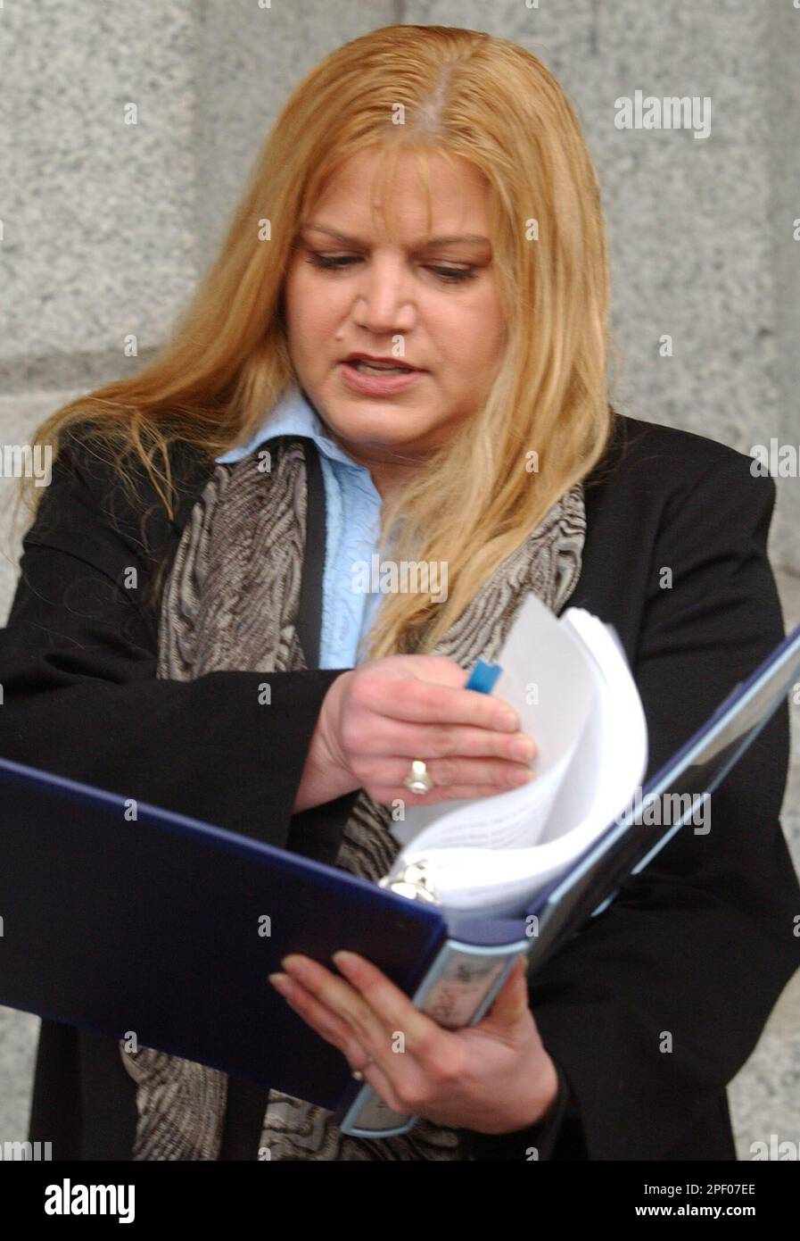 Tricia Griffith of Forums for Justice.org leafs through a binder of ...