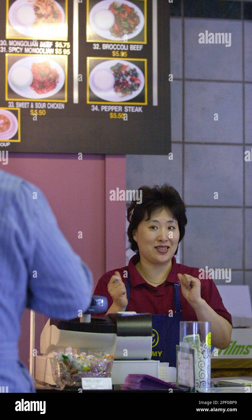 Restaurant owner Sunny Ho serves a customer in her small teriyaki shop ...