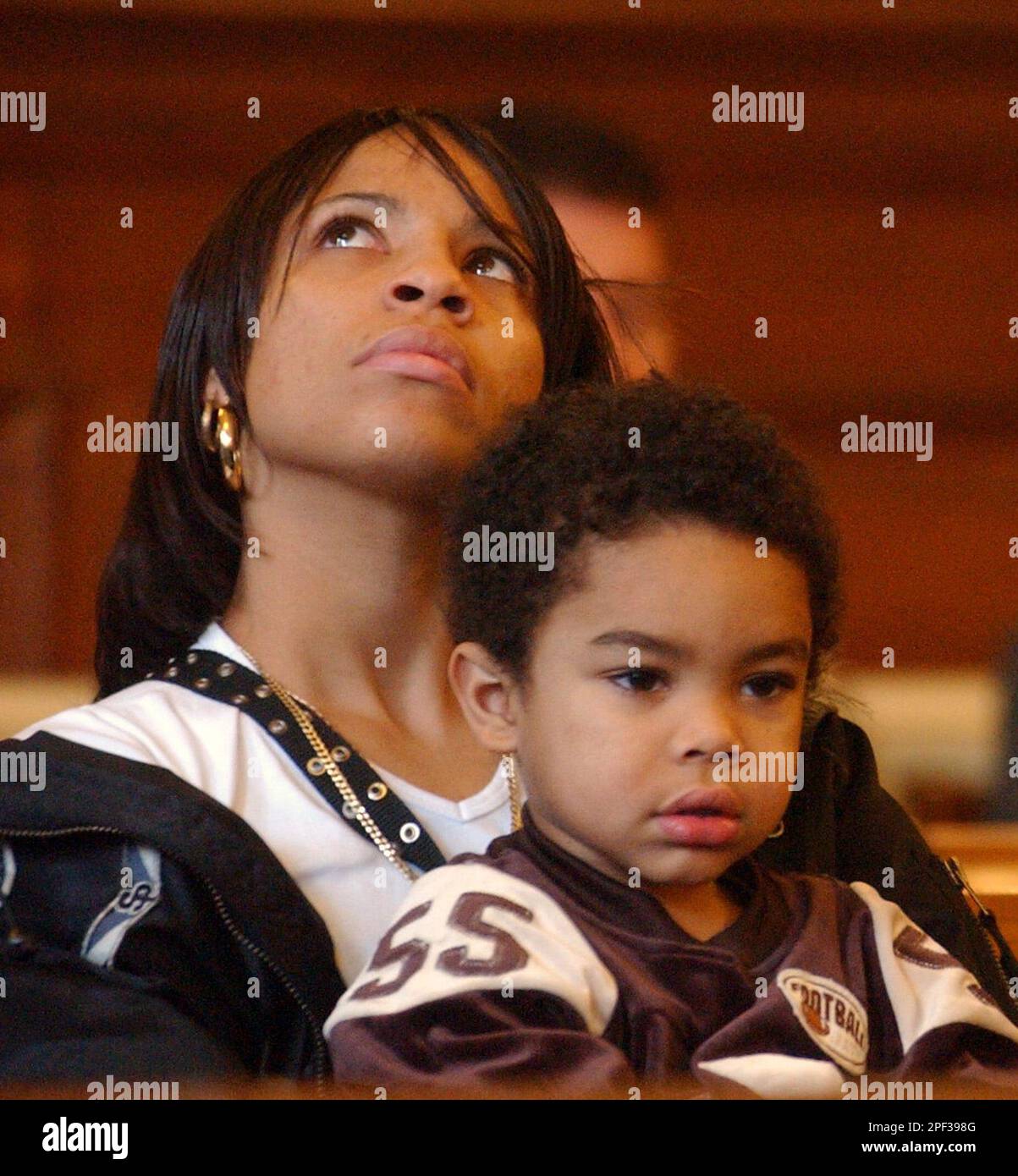 Tiqua Pona holds her newphew Charles Pona Jr., as she listens during ...