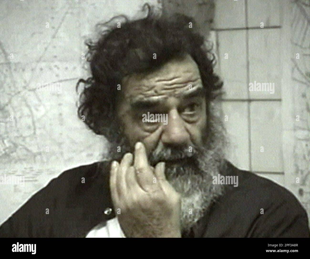Captured former Iraqi leader Saddam Hussein pauses in Baghdad Sunday ...