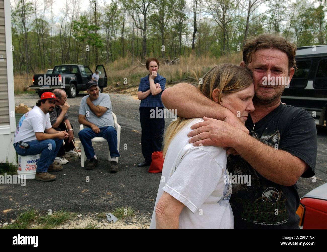 Angela Shutley, second from right, is comforted Wednesday, April 16 ...