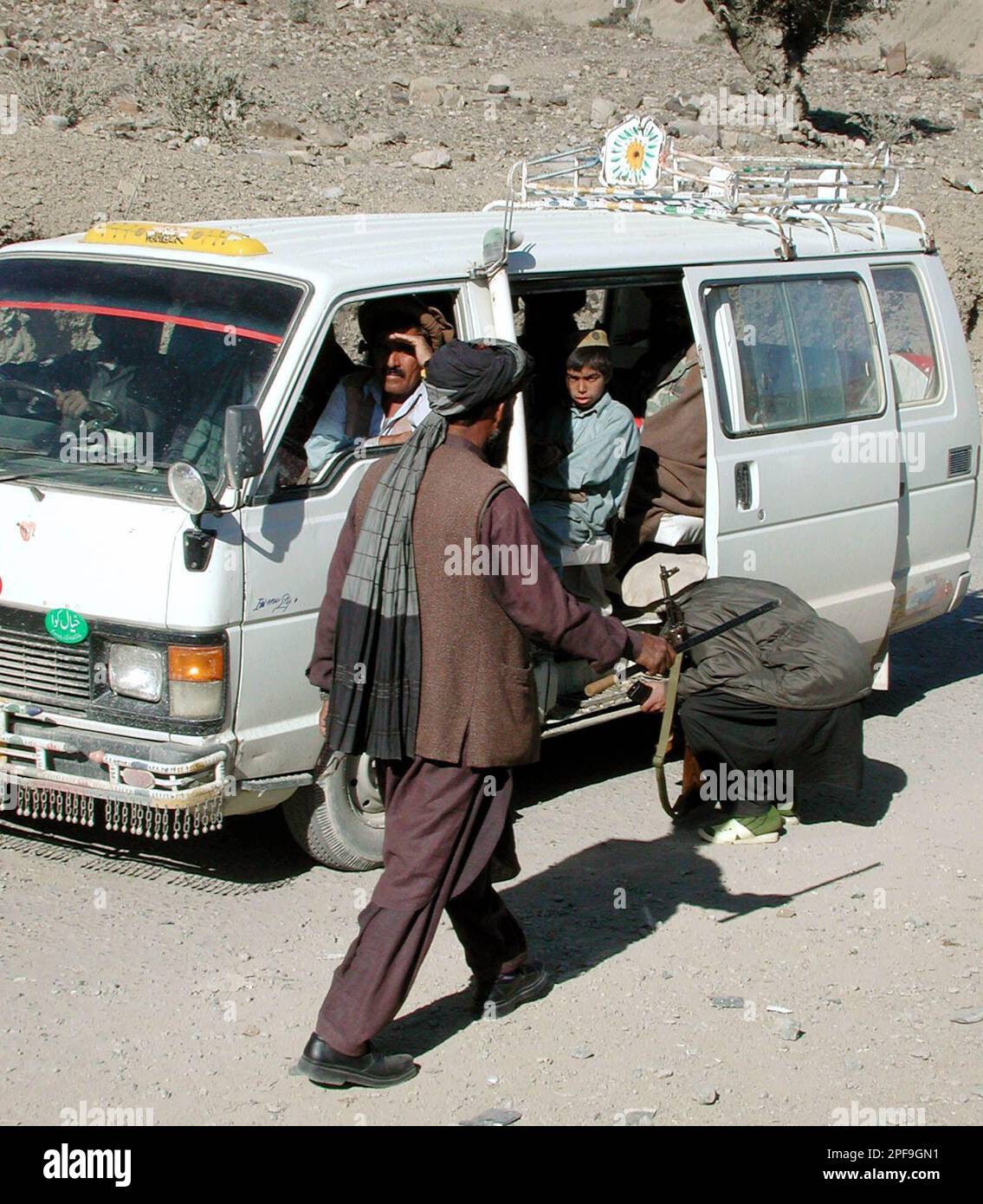 Pakistani border guards search a passenger wagon crossing the Pakistan ...