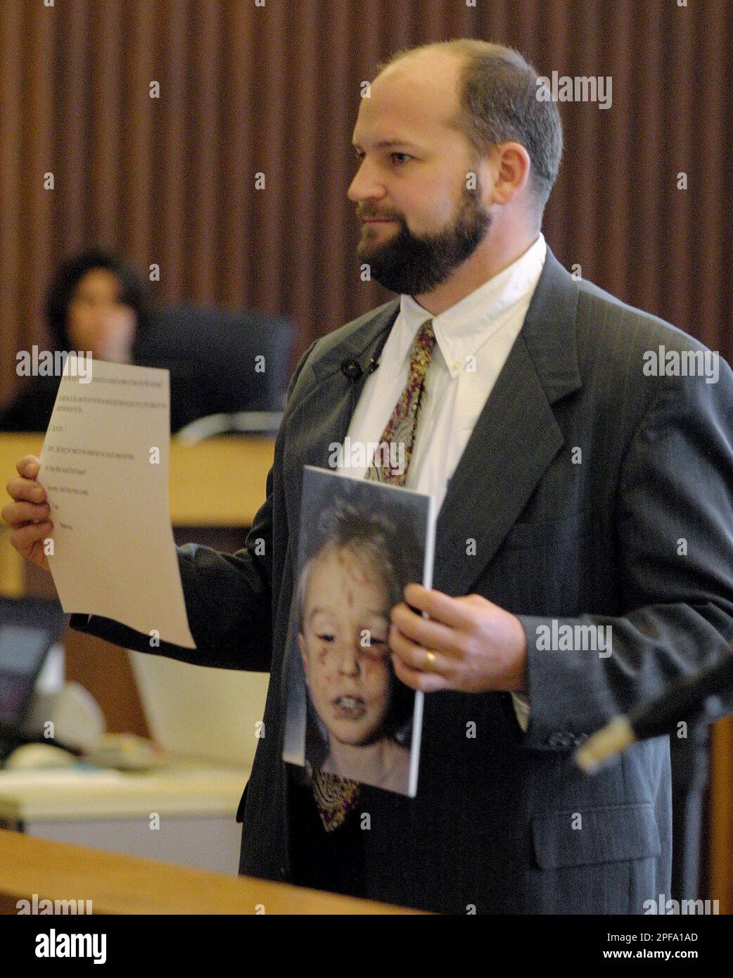 Proscecutor David Rouff holds an autopsy photo of 1-year-old Kassidy ...