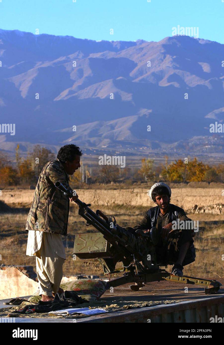 Two Afghan soldiers stand guard with thier anti-aircraft machine-gun on ...