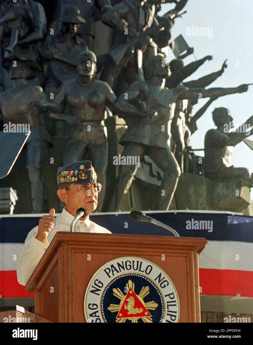 Philippine President Fidel Ramos flashes the thumbs up sign as he delivers his speech for the ...