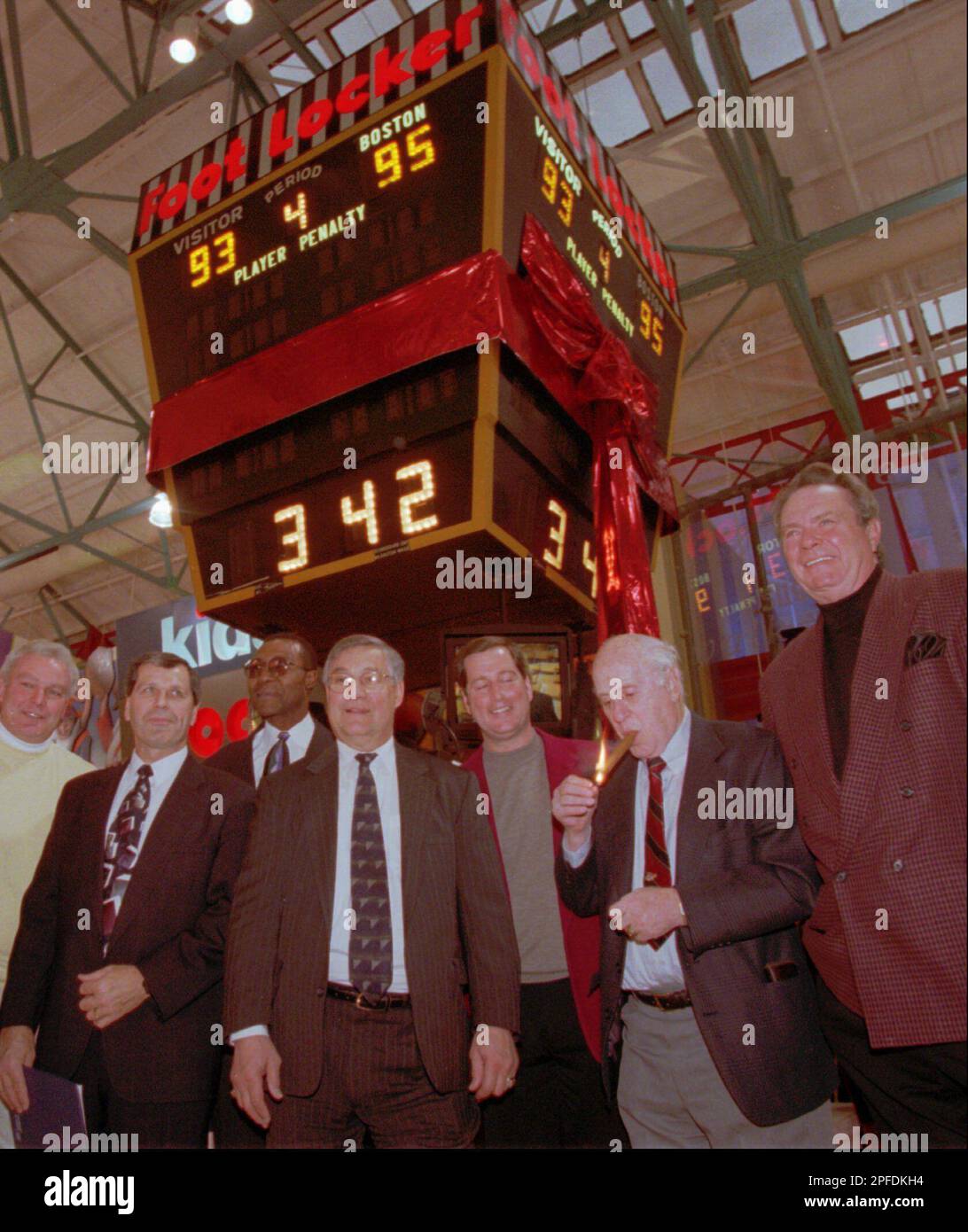 Boston Celtics legend Red Auerbach, second from right, lights his ...