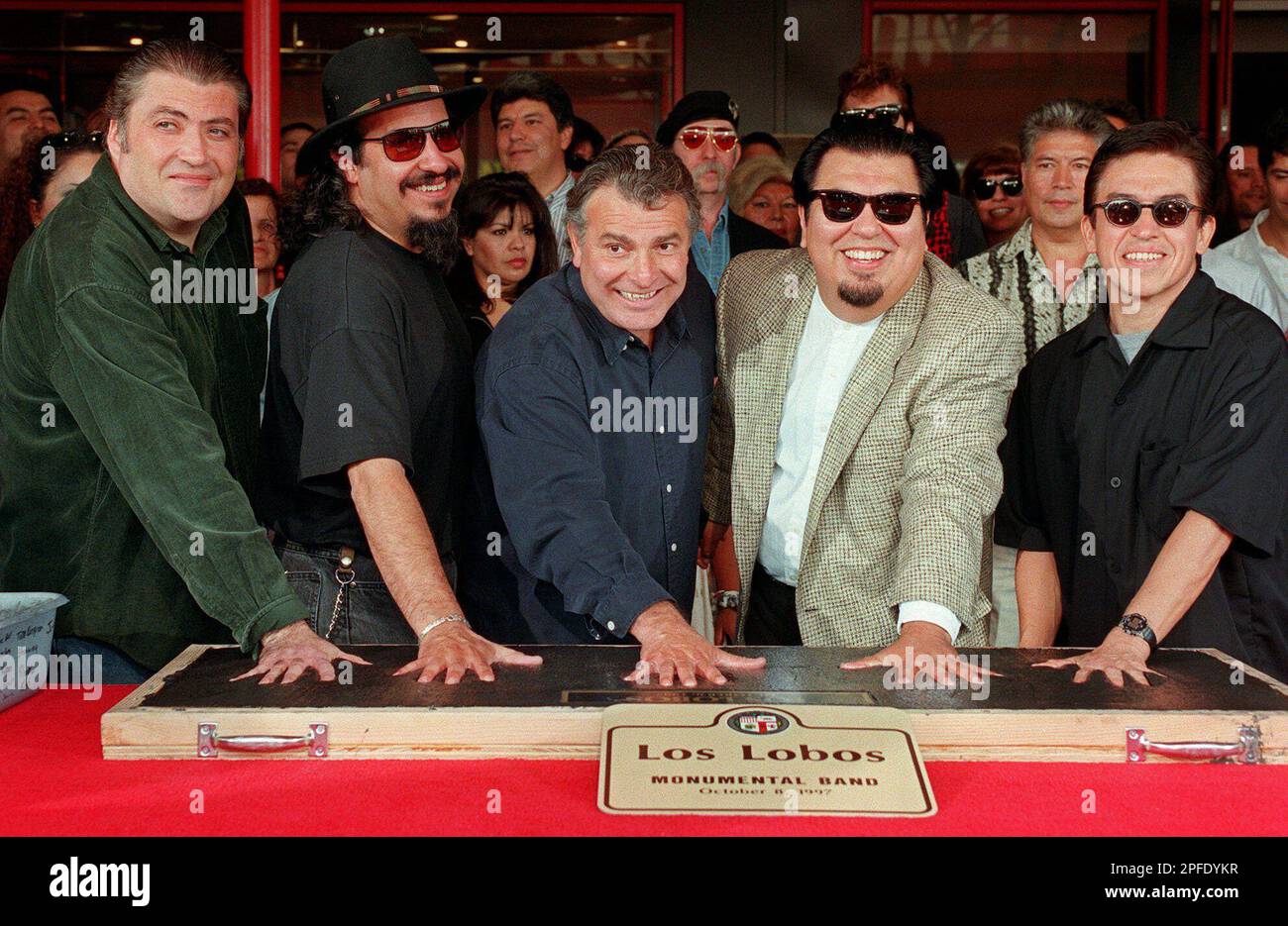 Members of the rock band Los Lobos put their handprints in a plaque ...
