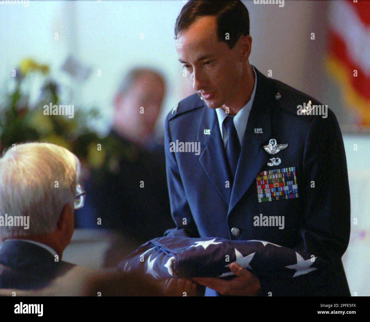 U.S. Air Force Col. Dave Clary, right, presents the flag to James ...