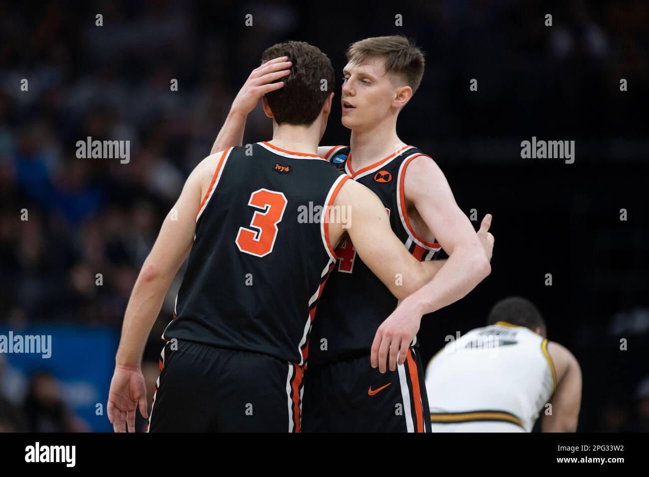 Princeton guard Matt Allocco (14) and teammate guard Ryan Langborg (3) embrace in the final ...