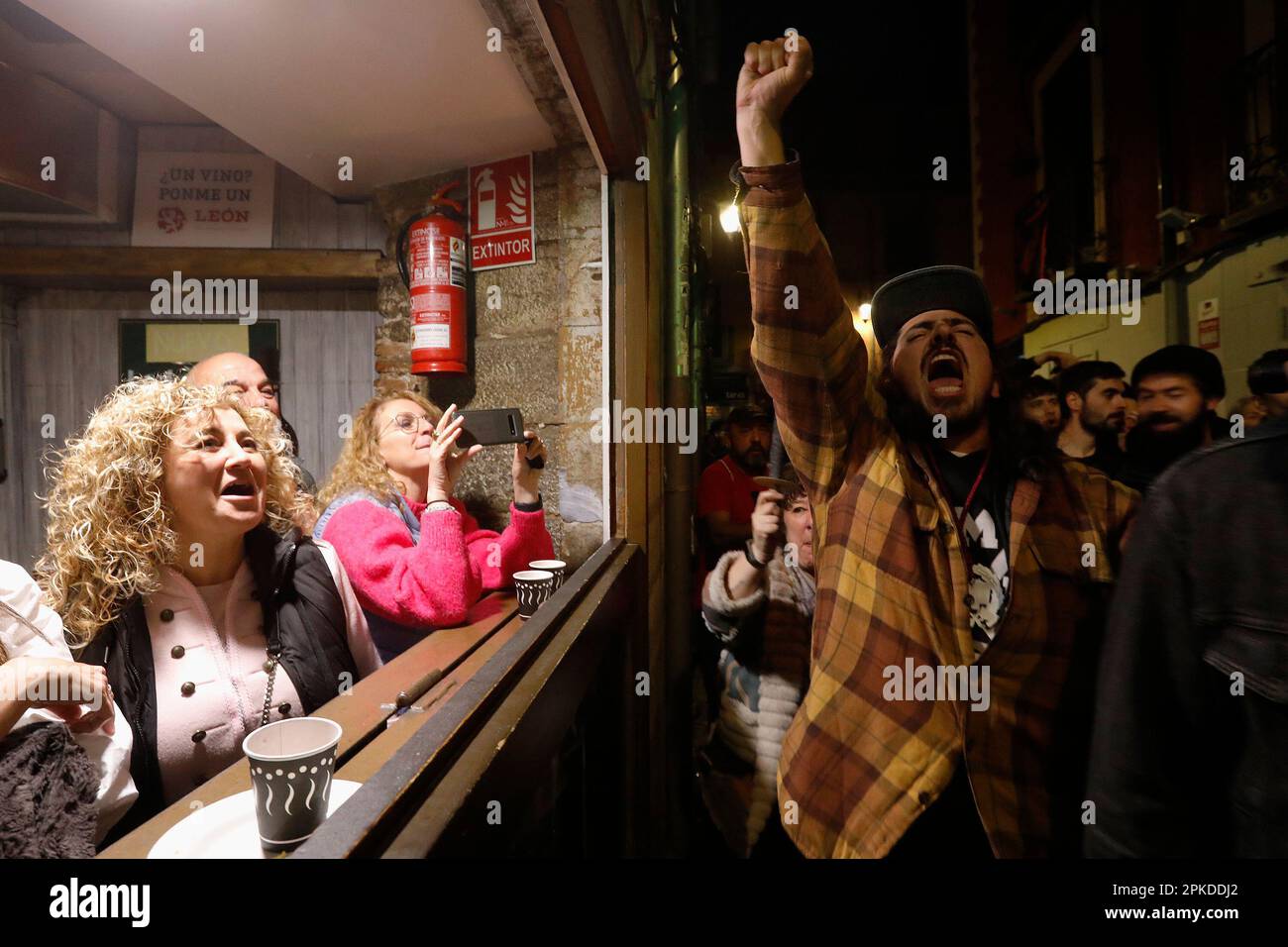 Several people have a drink in a bar during the procession and burial ...