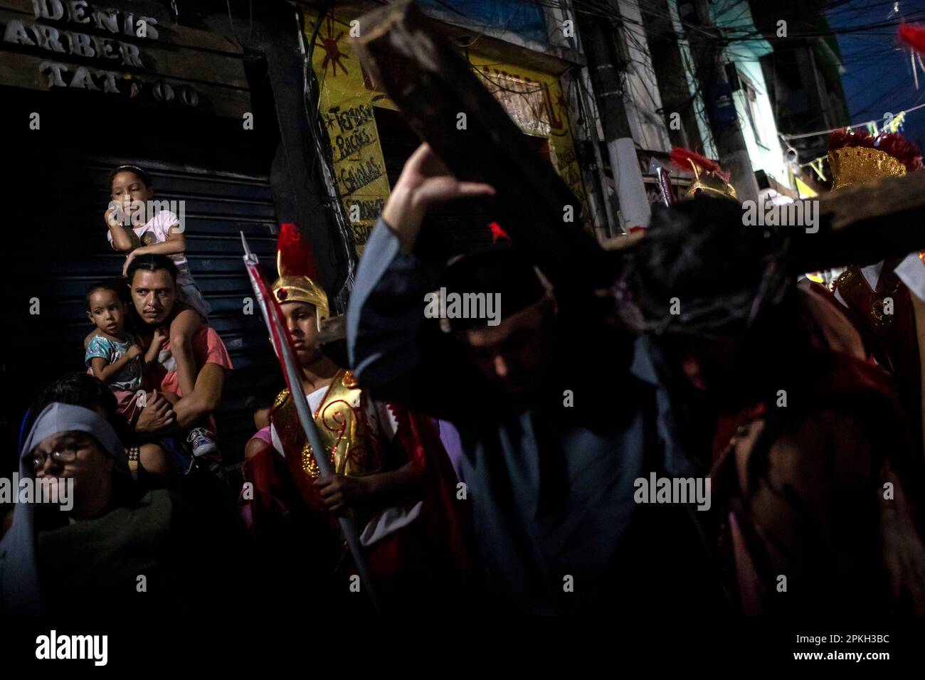 Residents watch a Way of the Cross reenactment at the Complexo do ...