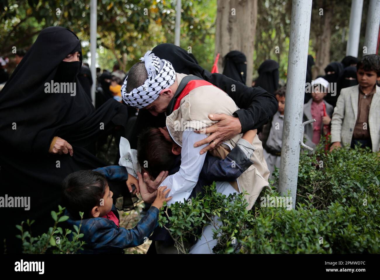 A Houthi prisoner hugs relative as he arrives to Sanaa airport ...