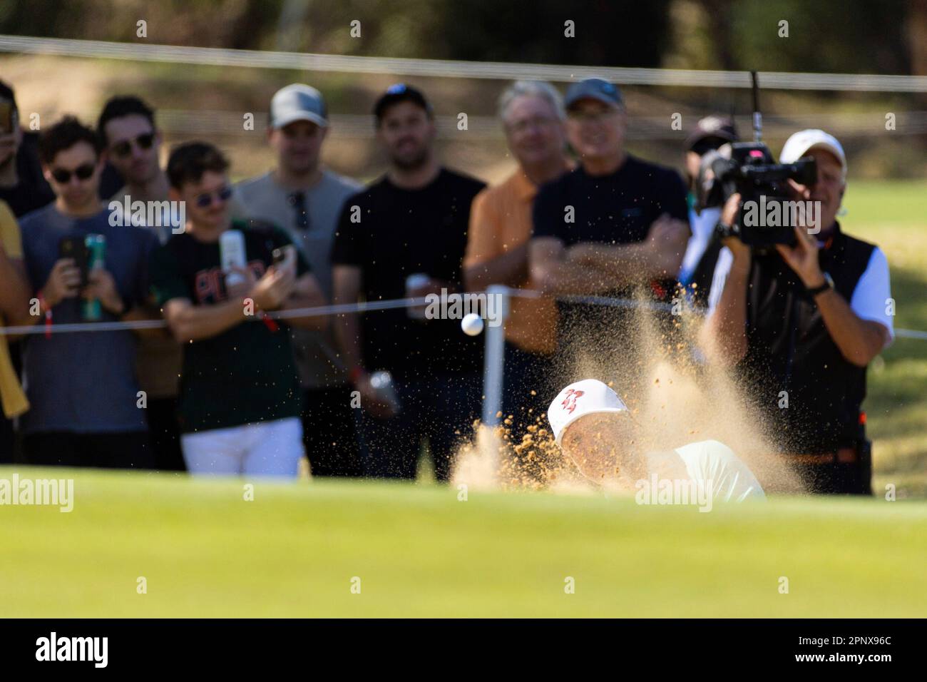 Matt Jones of Ripper GC hits his shot from a bunker on the first hole ...