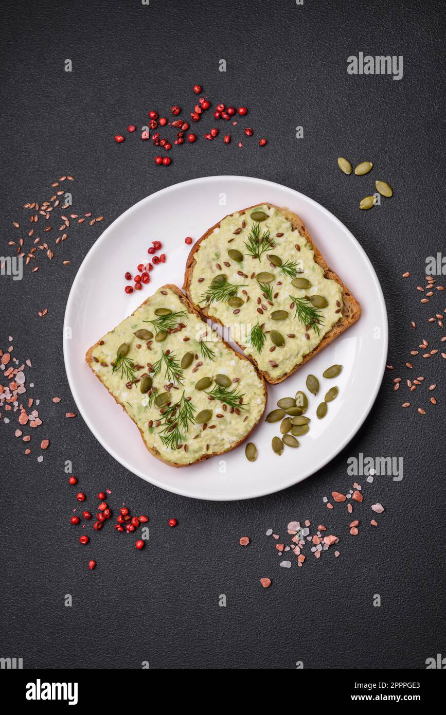 Toast grillé avec pâte d'avocat, œufs, fromage à la crème, sel, épices ...