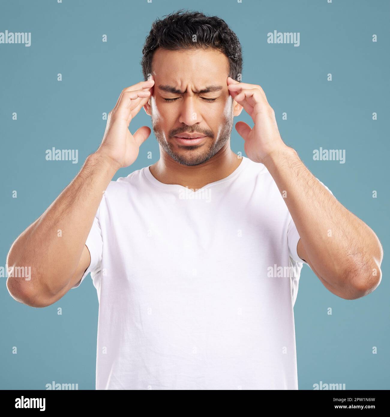 Beau jeune homme de course mixte souffrant d'un mal de tête avec ses ...