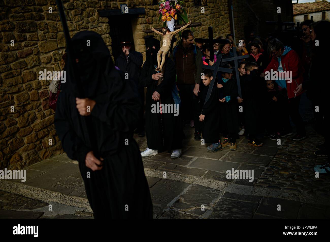 A Catholic penitent of the Ujue Virgin carries a crucifix decorated ...