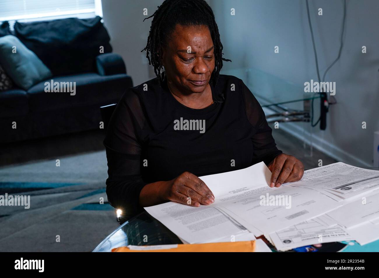 Debra Long looks through documents about the murder of her son, Randy ...