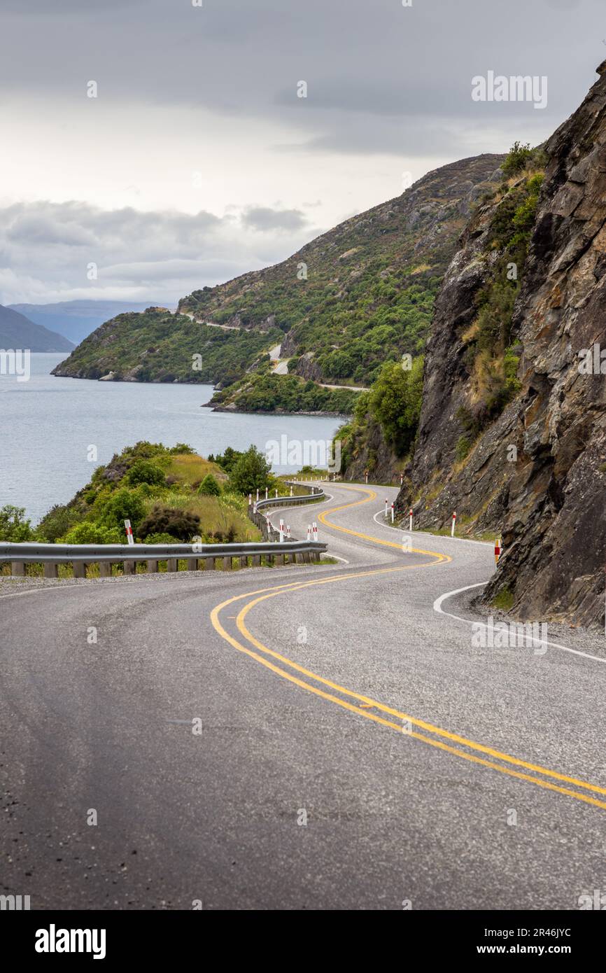 Une route de montagne sinueuse se trouve au premier plan d'un paysage à ...