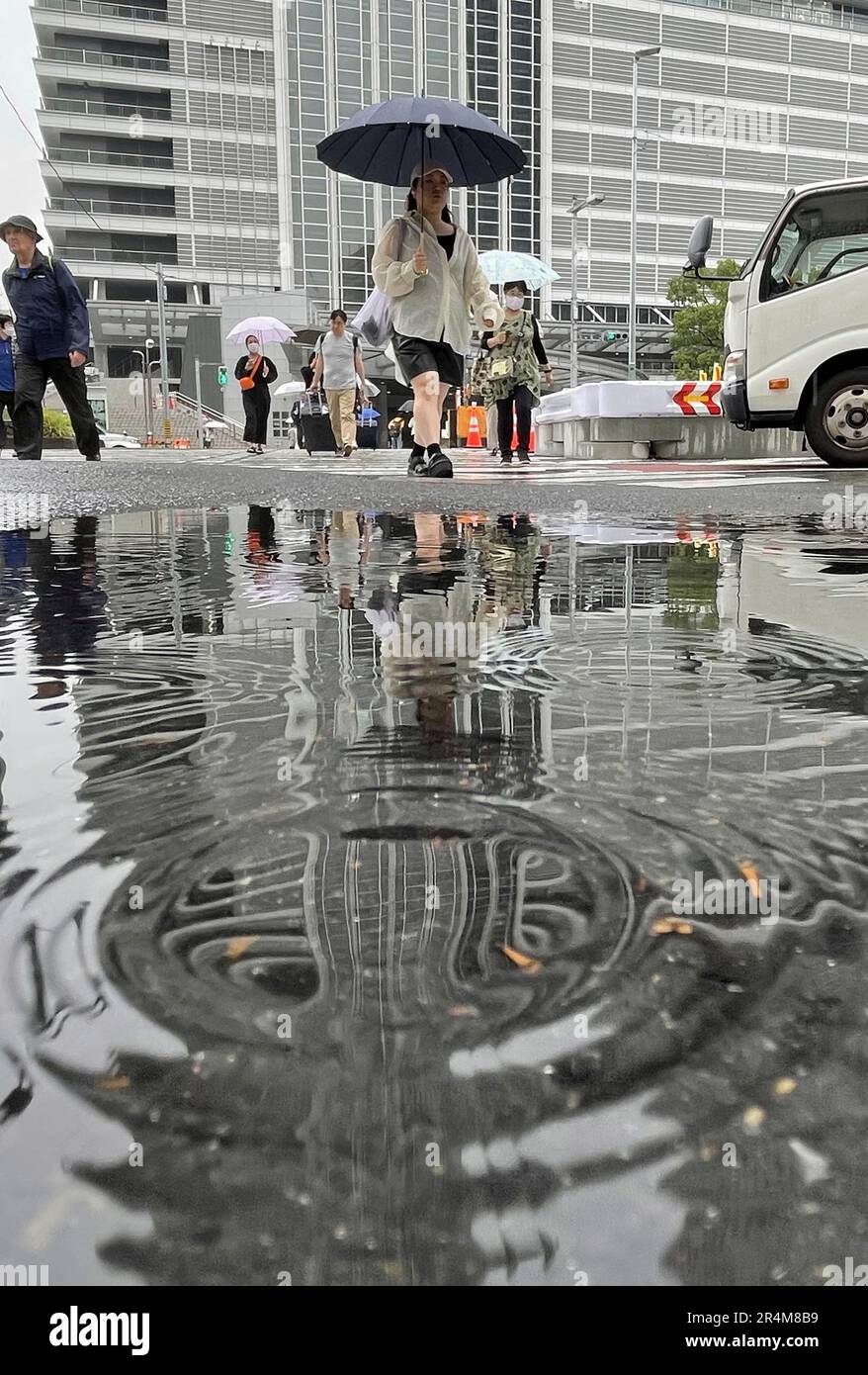 People walk in rain in Nagoya City, Aichi Prefecture on May 29, 2023 ...