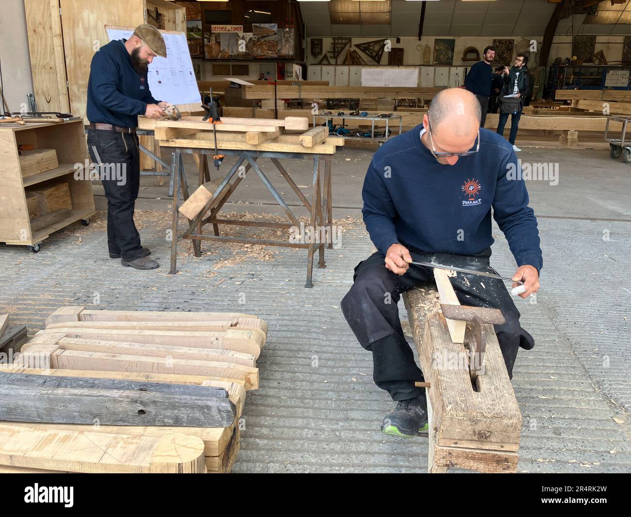 Carpenters work on pieces, part of the new roof for the Notre Dame de ...