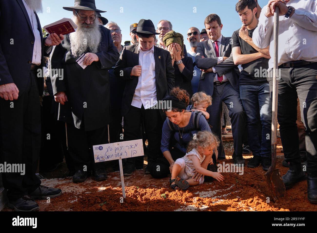 Israeli woman Tal Tamari, her two young children and others mourn over ...