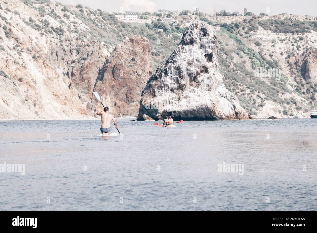 Vue latérale d'un homme qui nage et se détend sur le panneau supérieur ...