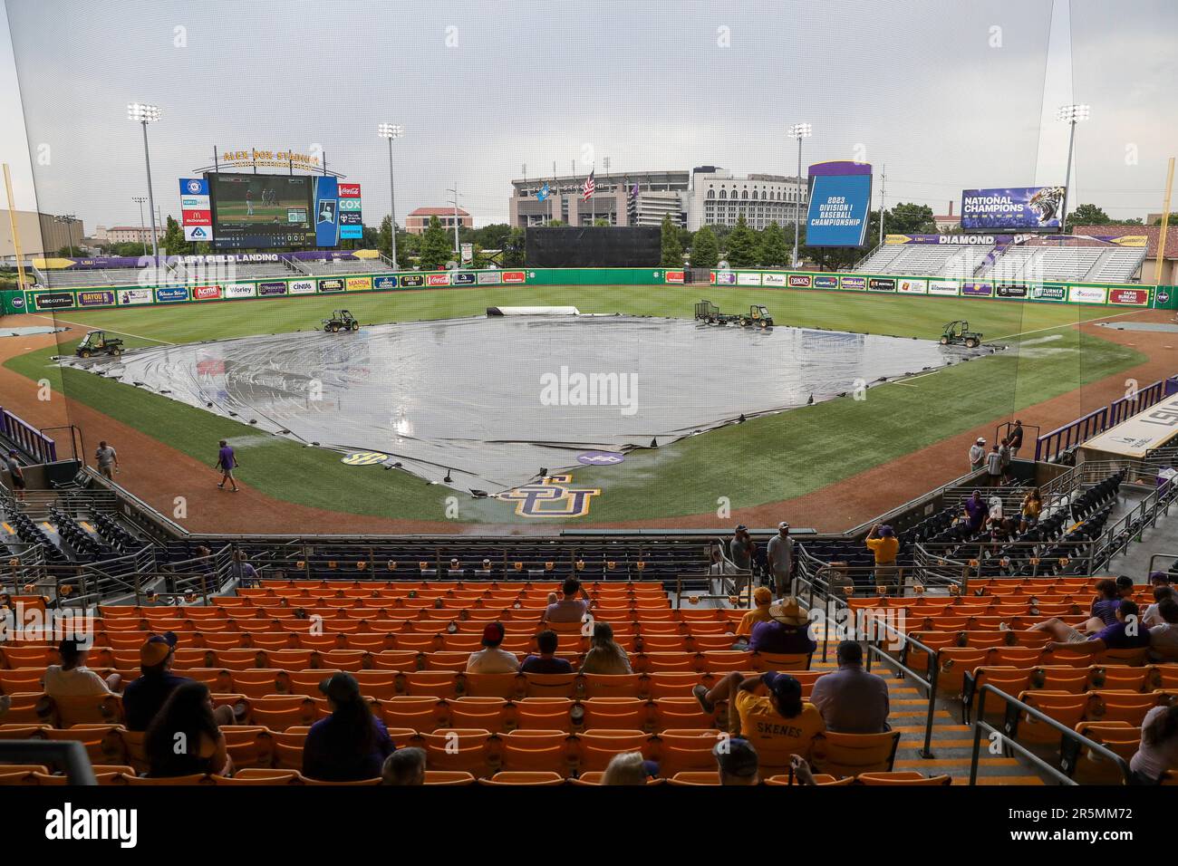 June 4, 2023: The tarp sits on the infield of Alex Box Stadium as play ...