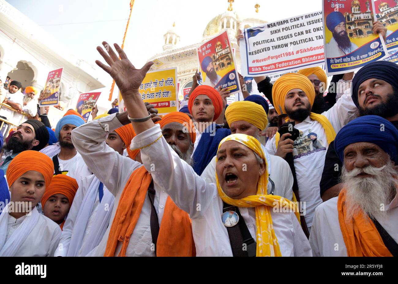 Activists from various Sikh organisations hold placards showing ...