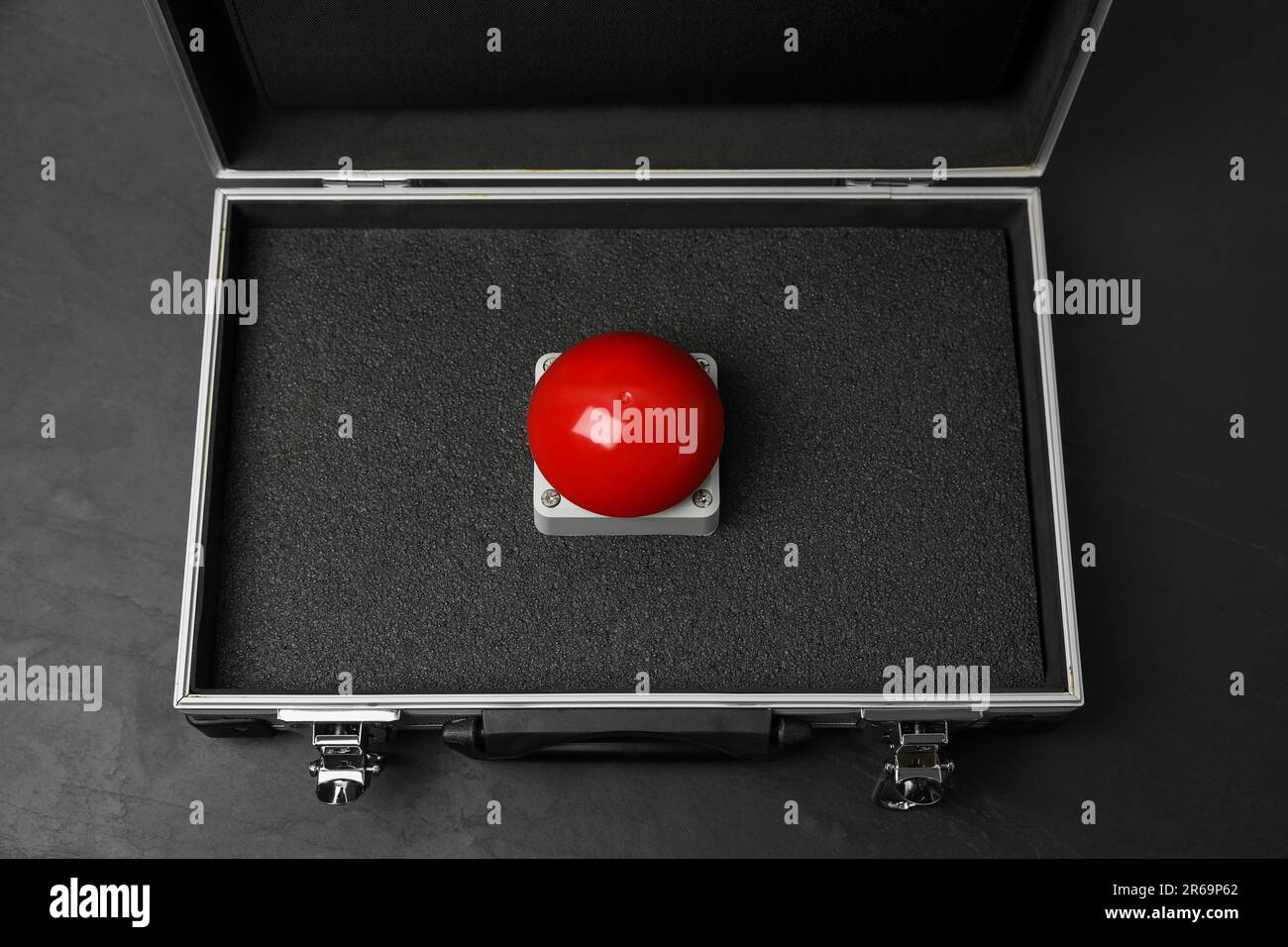 Bouton rouge de l'arme nucléaire dans une valise sur fond noir, vue au ...