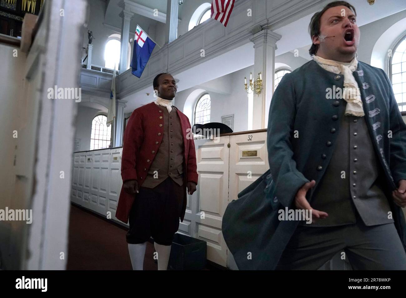 Actor Nathan Johnson, in the role of Cato, left, performs with actor ...