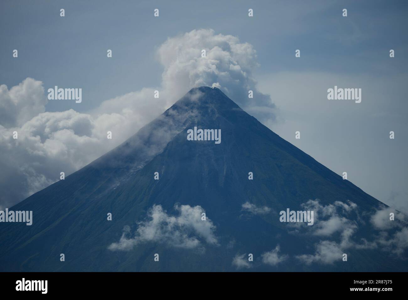Mayon volcano spews white smoke as seen from a government declared ...