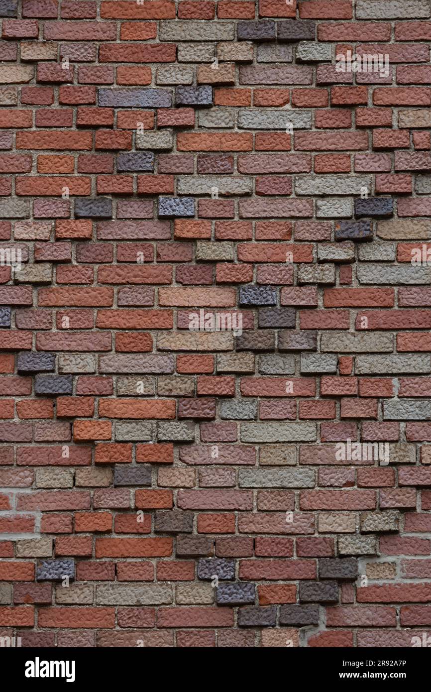 Mur de briques dans des tons de rouge, de brun, de beige et de gris ...