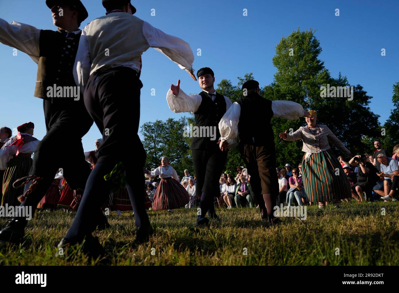 People dressed in traditional clothing dance during celebrations of ...
