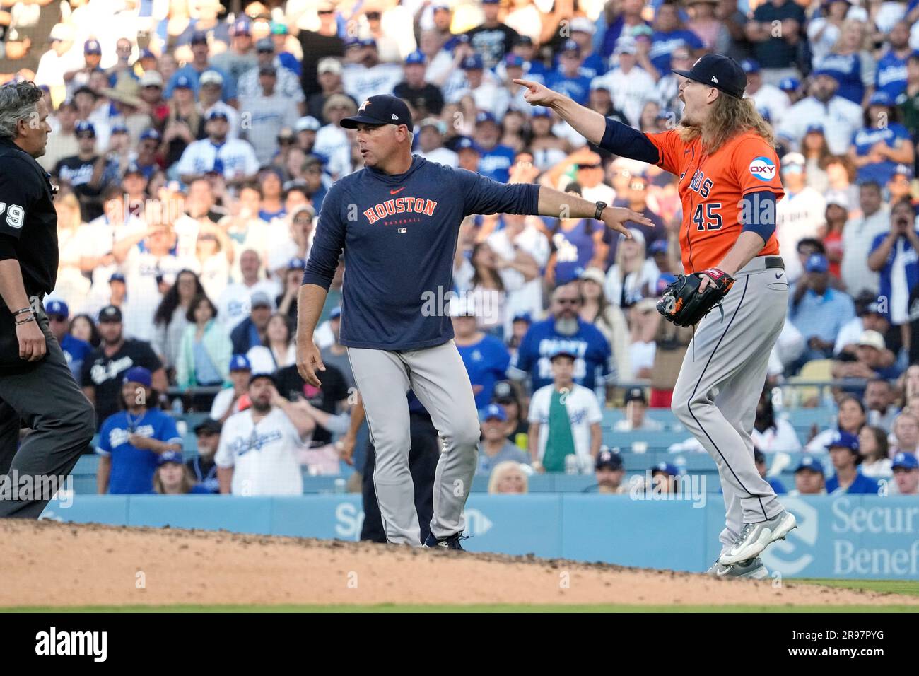 Houston Astros relief pitcher Ryne Stanek, right, is held back by a ...