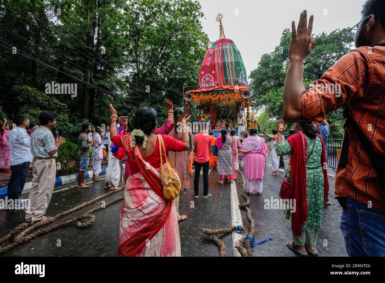 Hindu devotees chant devotional songs in front of a chariot during the Rath Yatra, or chariot ...