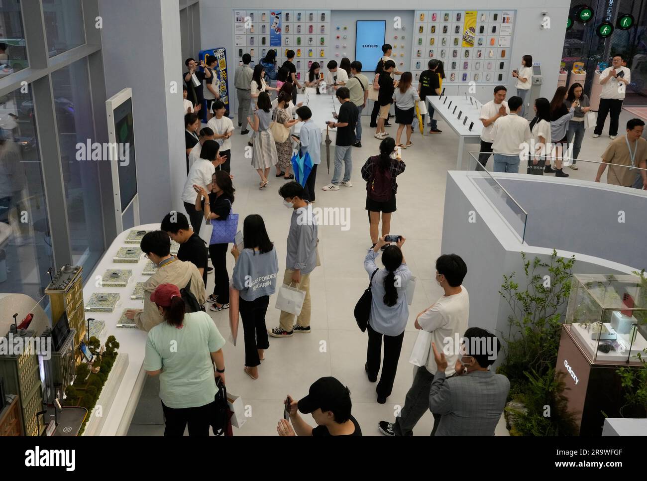 People visit Samsung Electronics Co.'s new store in Seoul, South Korea ...