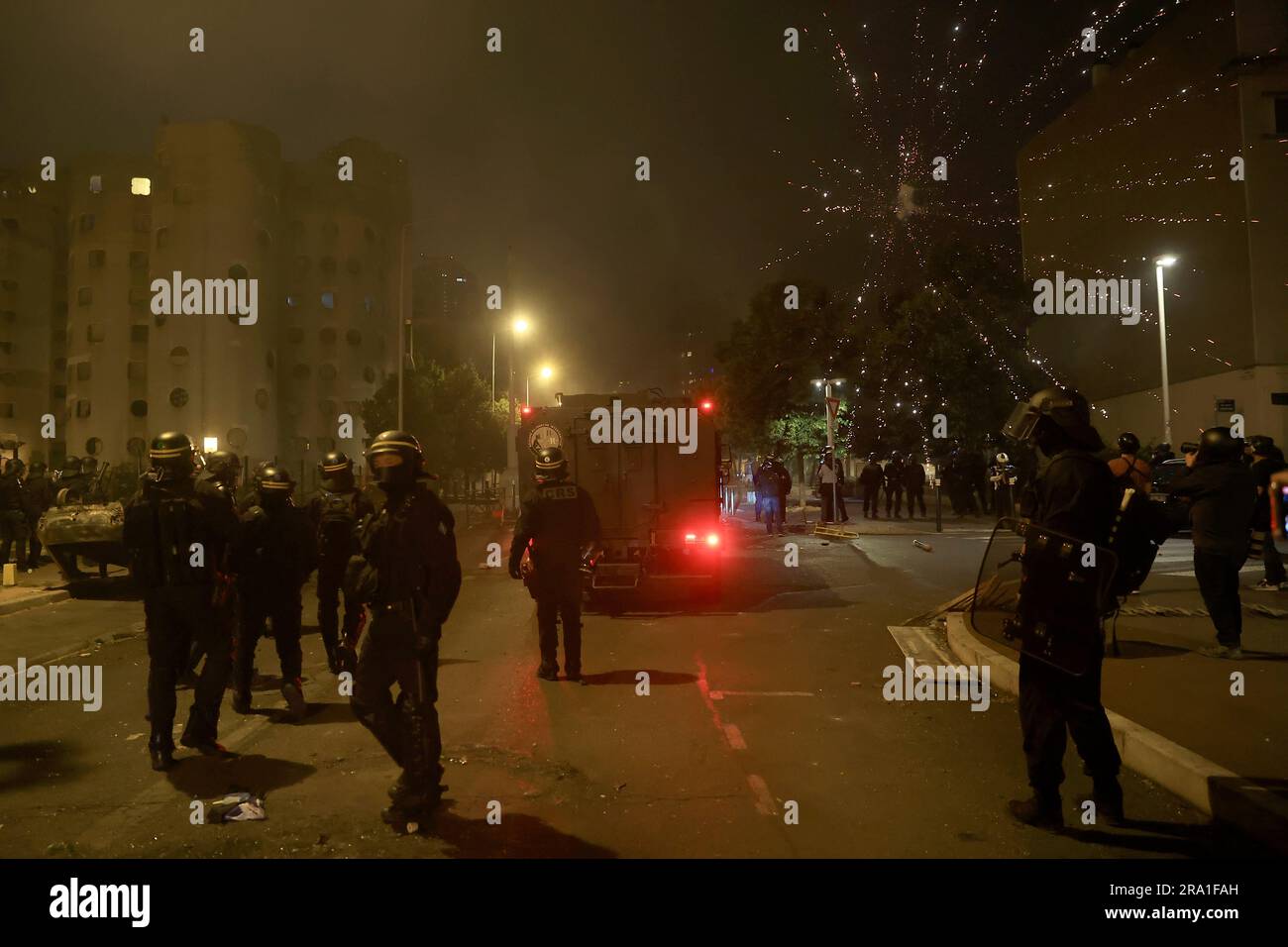 Riot police officers patrol on the third night of protests sparked by ...