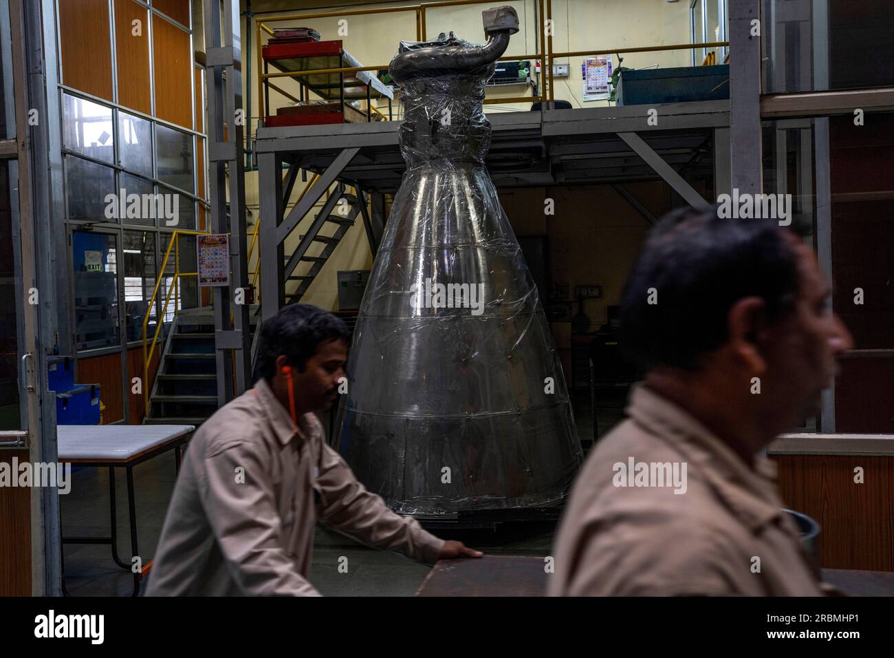 CORRECTS DATE TO JULY 10 - Workers walk past Vikas rocket engine, a ...