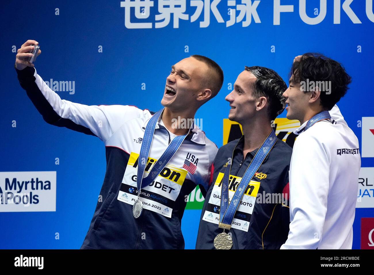 Silver medalist Kenneth Gaudet, left, of United States, takes a picture ...